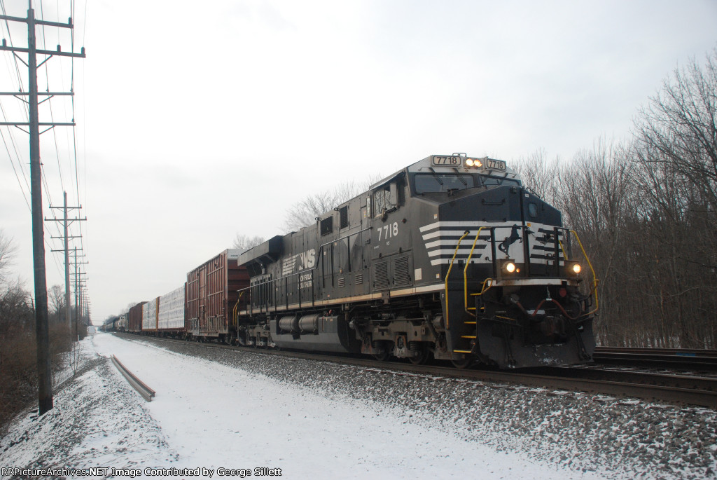 NS 7718 takes a string of cars east solo.